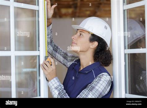 A Woman Measuring Window Frame Stock Photo Alamy