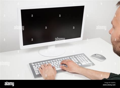 Man Typing On A Computer Stock Photo Alamy