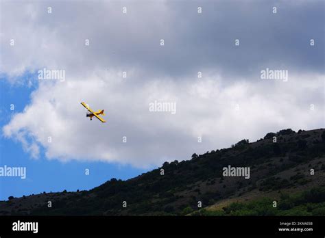 Small Single Engine Propeller Plane Flying Within Clouds In A Sunny Day