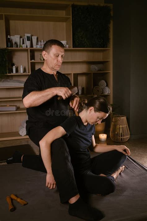 Male Master Giving Thai Toksen Massage To Girl In Massage Room A Girl