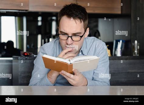 Leisure Literature And People Concept Reading Book At Home Reader Is Reading Interesting Novel