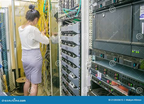 A Woman Works In A Server Room The Girl Switches The Wires In The Routers Of The Internet