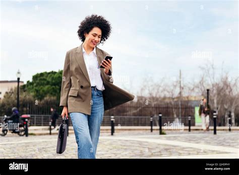 Business Woman Walking Confidently Using A Phone Stock Photo Alamy