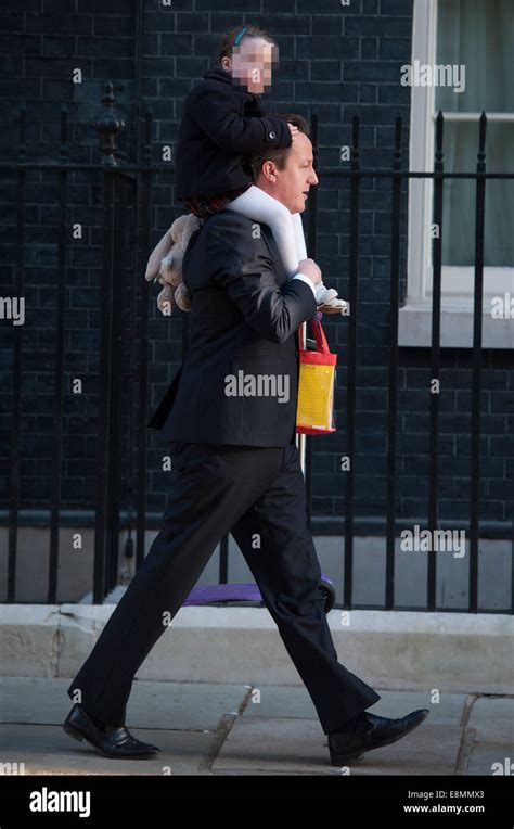 David Cameron Leaves Downing Street Carrying His Daughter Nancy On His Shoulders Featuring