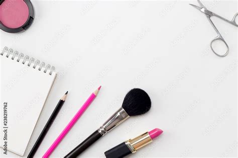 Workspace With Notebook Black And Pink Pencils Lipstick Blusher Make Up Brush And Scissors