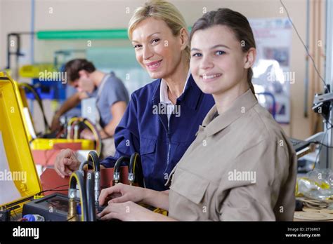 Two Working Women At Factory Putting Cables Together Stock Photo Alamy