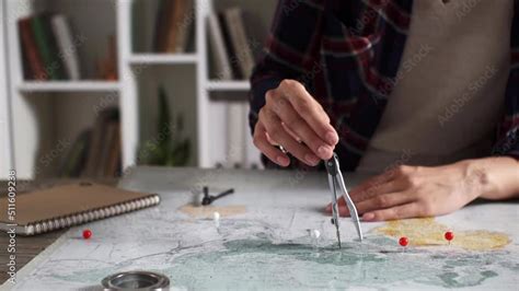 A Woman Traveler Makes Measurements On A Map To Determine The Distance A Route Plan The Hands