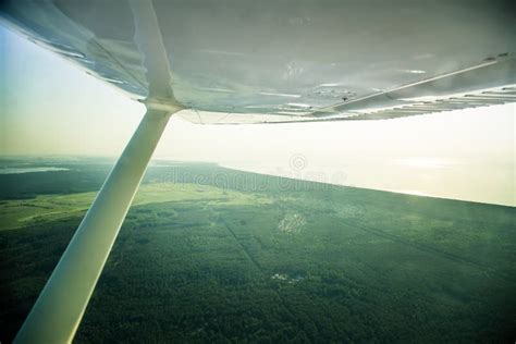 A Beautiful Aero Landscape Looking Out Of A Small Plane Window Under