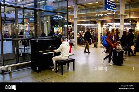 Man Playing One Of The Pianos In St Pancras International Railway