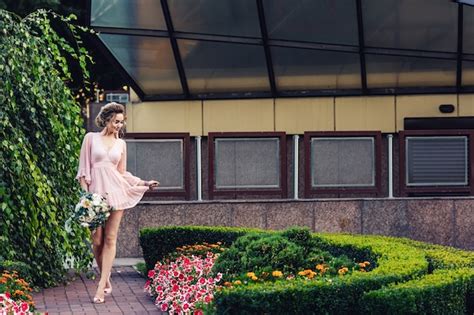 Premium Photo Sexy Young Girl In A Short Pink Dress Posing Walking In