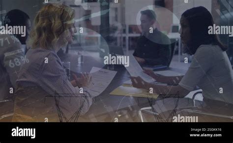 Statistical Data Processing Against Two Diverse Female Office Colleagues Stock Video Footage Alamy