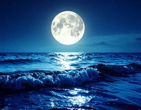 A Calm Surreal Moonlit Ocean With Gentle Waves And A Full Moon Casting