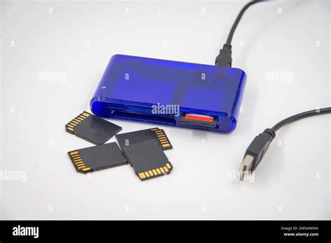 Black Memory Cards With A Blue Card Reader And A Card In It On A White Background Stock Photo