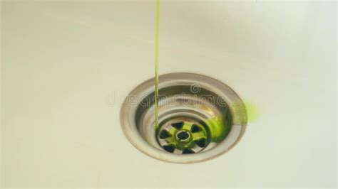 Person Pours Green Detergent Into Overflow Hole Of Sink Stock Video Person Pours Green Detergent Into Overflow Hole Of Sink Stock Video
