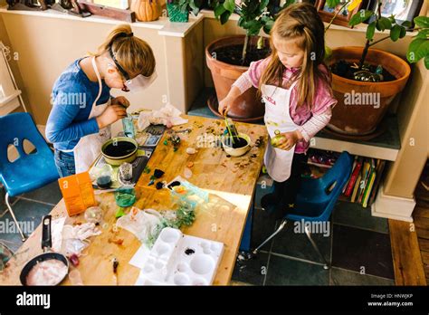 Two Girls Doing Science Experiments At Messy Table Stock Photo Alamy