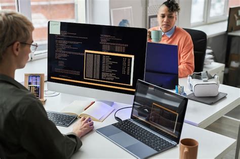 Premium Photo Programmers Working With Codes On Computers In Office