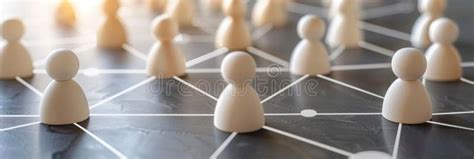 Wooden Figures Interconnected On A Network Grid Representing Concepts Of Social Media Teamwork
