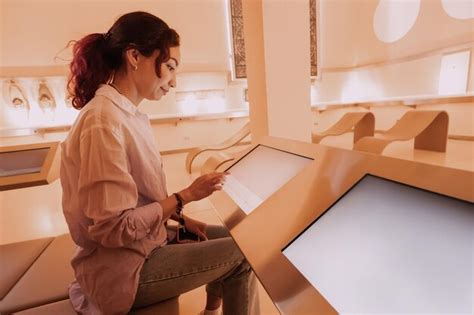 Premium Photo The Girl Uses A Touchscreen Terminal To Get Information And Education