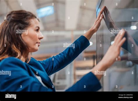 Businesswoman Touching Screen Of Computer In Industry Stock Photo Alamy