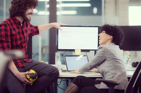 Premium Photo Young Software Developers Couple Using Laptop And Desktop Computer While Writing