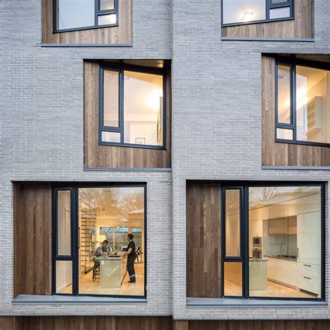 캐나다 주거용 건물은 큰 간격으로 분리된 2개의 구조로 구성되어 있다 회색 벽돌로 꾸며진 외벽은 따뜻한 목재를 활용해 강조되고 다양한 크기의 창문은 약간 움푹 들어가거나