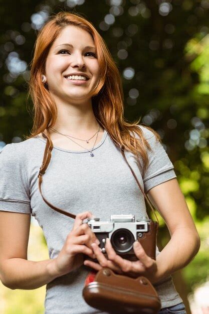 Premium Photo Pretty Redhead Holding Her Camera