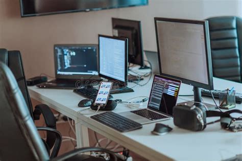 Computer Screens Running Programming Code In Empty Software Developing Agency Office And