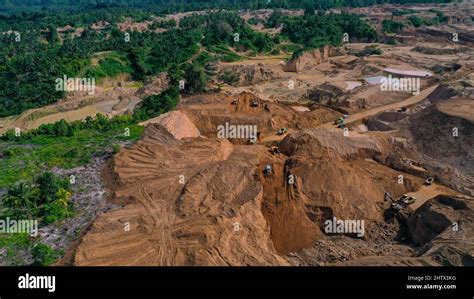 Aerial View Of Work Of Trucks And The Excavator In An Open Pit On Gold Mining Central Sulawesi