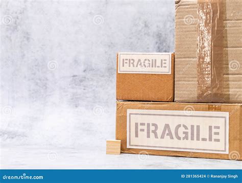 High Angle Shot Of Fragile Boxes Along With Wooden Cube Placed On