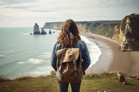 Premium Ai Image Intrepid Young Woman Bravely Approaches The Cliffs Edge Gazing Out At The