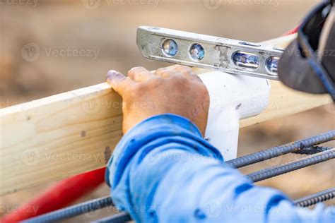 Plumber Using Level While Installing PVC Pipe At Construction Site 16444809 Stock Photo At Vecteezy