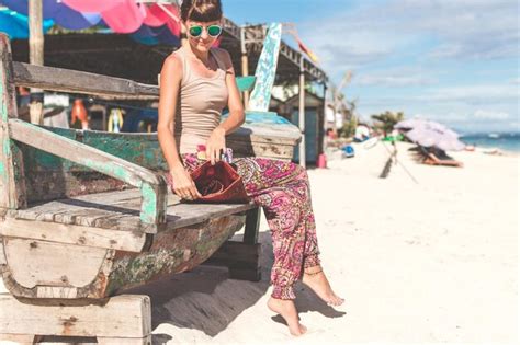 Premium Photo Girl On The Beach Holding A Clutch Made Of Exotic Premium Photo Girl On The Beach Holding A Clutch Made Of Exotic