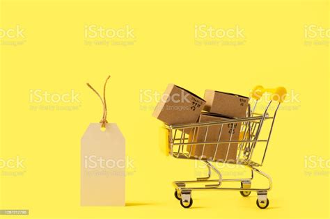 노란색 배경에 상자와 빈 태그장난감 쇼핑 카트 텍스트 또는 디자인공간을 복사합니다 판매 할인 쇼핑 및 배달 개념 소비자 사회 동향 0명에 대한 스톡 사진 및 기타 이미지
