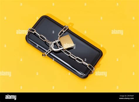 Phone Security Concept Smartphone Locked With Chain And Padlock On Yellow Background Mobile