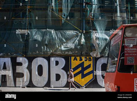 A Woman Walks By Street Art Depicting The Azov Battalion Symbol In Lviv On May 18 2022 A