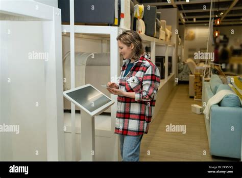 Woman Uses The Self Service Kiosk In The Store Stock Photo Alamy