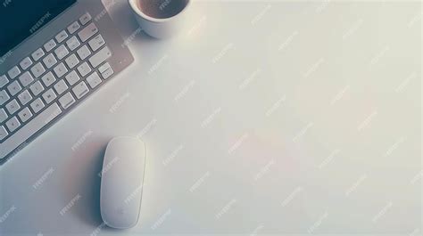 Top View Of A Desk With A Keyboard Mouse And Coffee Cup The Keyboard And Mouse Are White Placed
