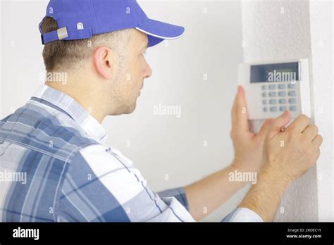 Man Installing Security System On Wall Stock Photo Alamy