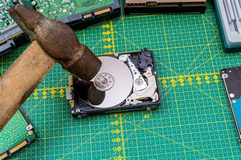 Premium Photo Destruction Deleting Of Data Information On A Hard Disk Drive With Hammer