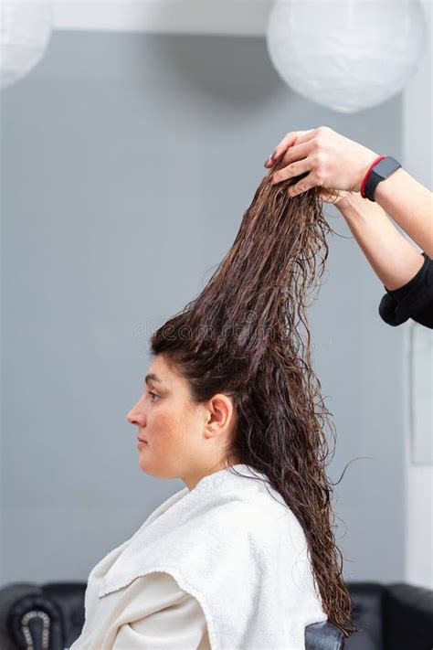 Hairstylist Massages Head And Scalp For A Young Female Client Stock