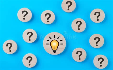 Problem Solving Concept Question Mark And Light Bulb Icons On Round Wooden On Blue Background
