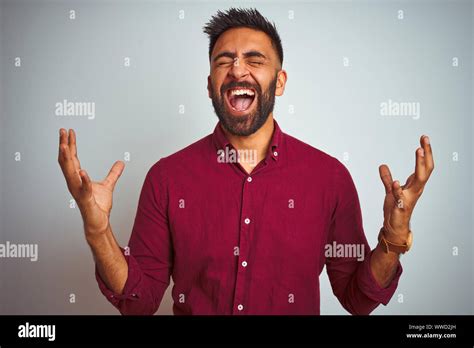 Young Indian Man Wearing Red Elegant Shirt Standing Over Isolated Grey