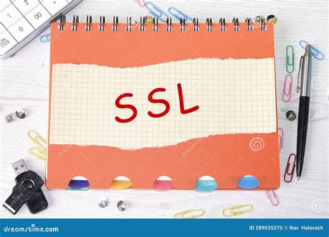 SSL Word Is Written On A Sheet In A Cage Lying On A Notebook On The Table Next To Stationery