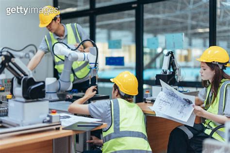 Trainees Programing Robotic Arm In Practical Lesson At Robotics Academy
