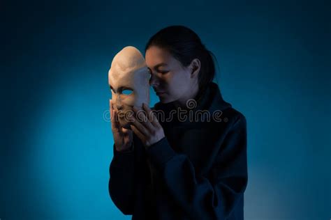 Hiding Behind A Mask A Young Woman In A Dark Hoodie Hides Her Face