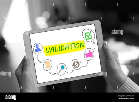 Validation Concept Shown On A Tablet Held By A Woman Stock Photo Alamy
