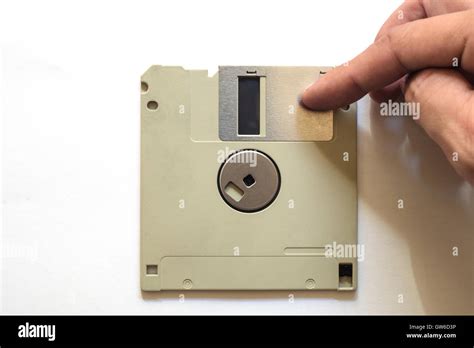 Detail Of Floppy Disc On A White Isolated Background A Hand Moves The Retractable Metal Sleeve