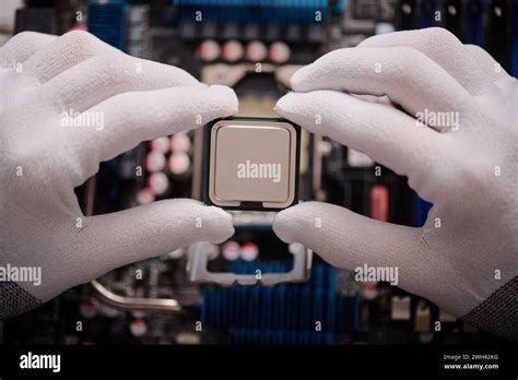 Unrecognizable Technician Carefully Holding CPU With Fingers Before Inserting It Into PC