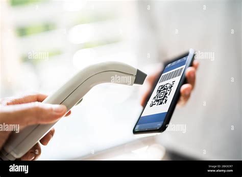 Using Mobile Phone To Scan Payment Code In Shop Stock Photo Alamy