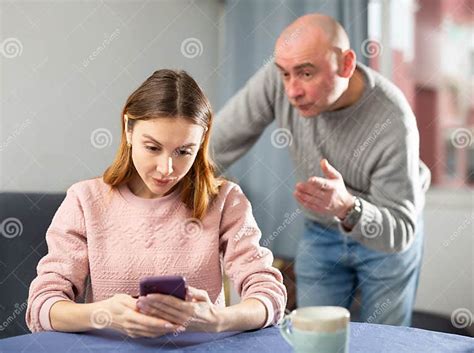 Man Controling How Woman Is Texting With Someone On A Mobile Phone Stock Image Image Of Woman